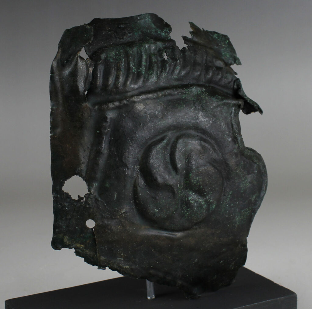 Roman military cheek piece of a helmet fragment with shield ornament ...